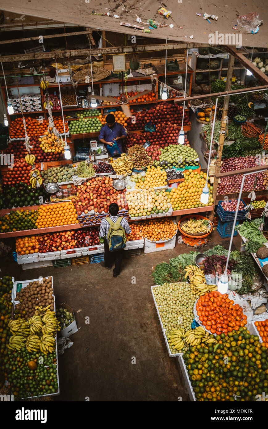 colorful busy fruit and produce market on a warm day in tropical Goa ...