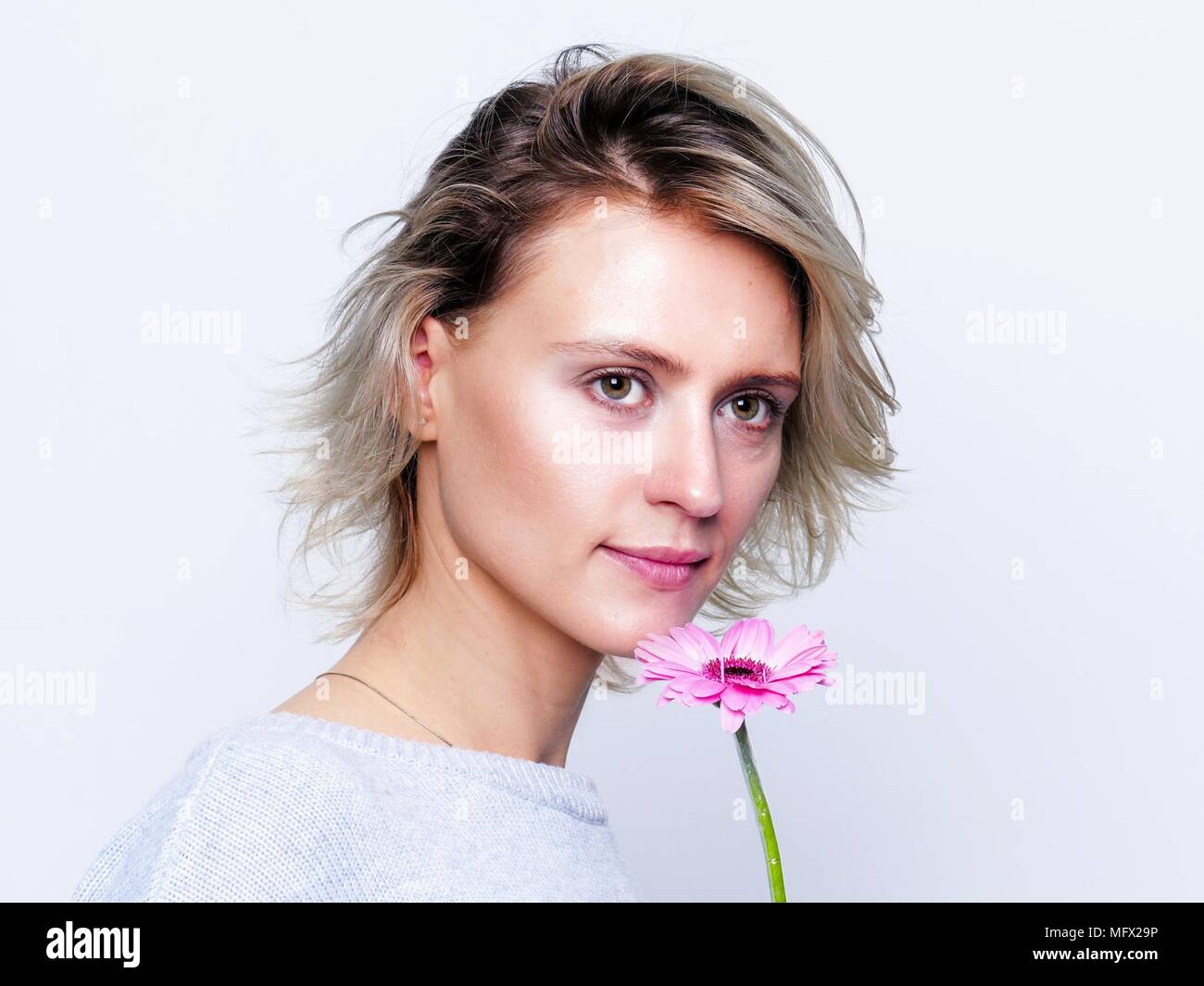 Romantic woman with pink flower Stock Photo - Alamy