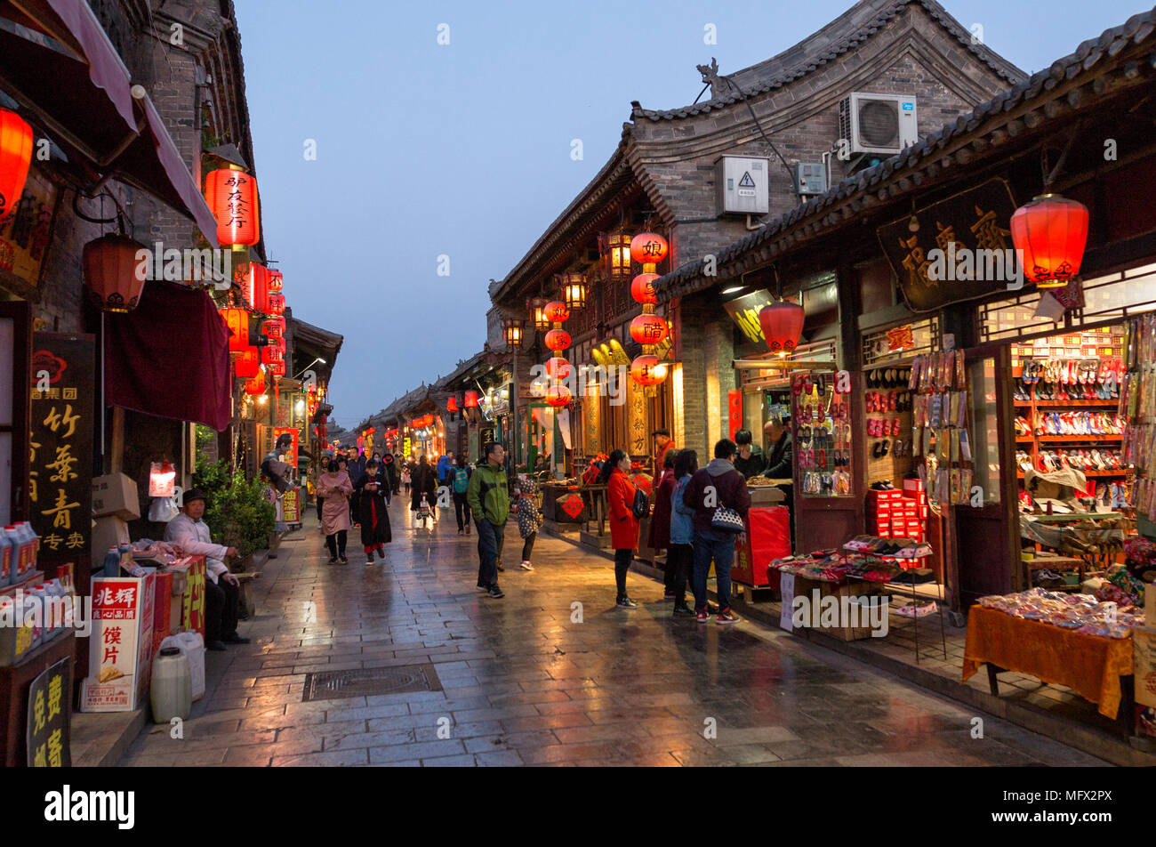 Tourists and local people in the ancient city of Pingyao in central ...