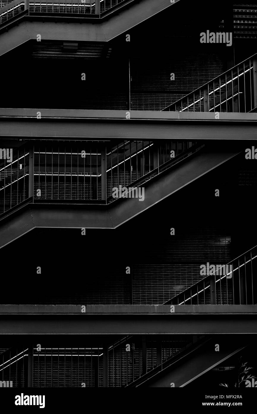 Multilevel parking garage exterior with close-up of metal stairs with ...