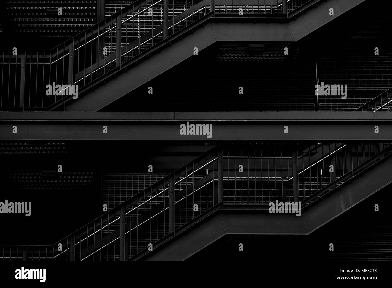 Multilevel parking garage exterior with close-up of metal stairs with ...