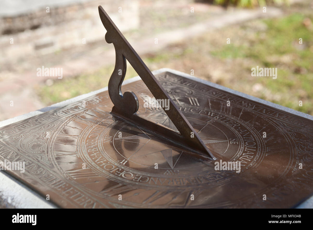 Still life of an antique handmade bronze sundial seen in the courtyard ...