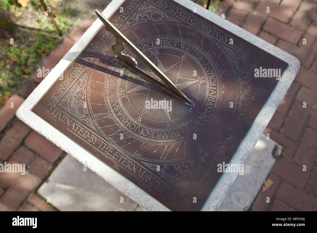 Still life of an antique handmade bronze sundial seen in the courtyard ...
