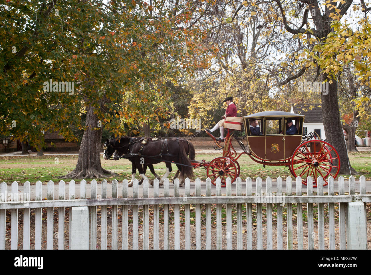 A horse drawn restored carriage and driver slowly make their way down N ...