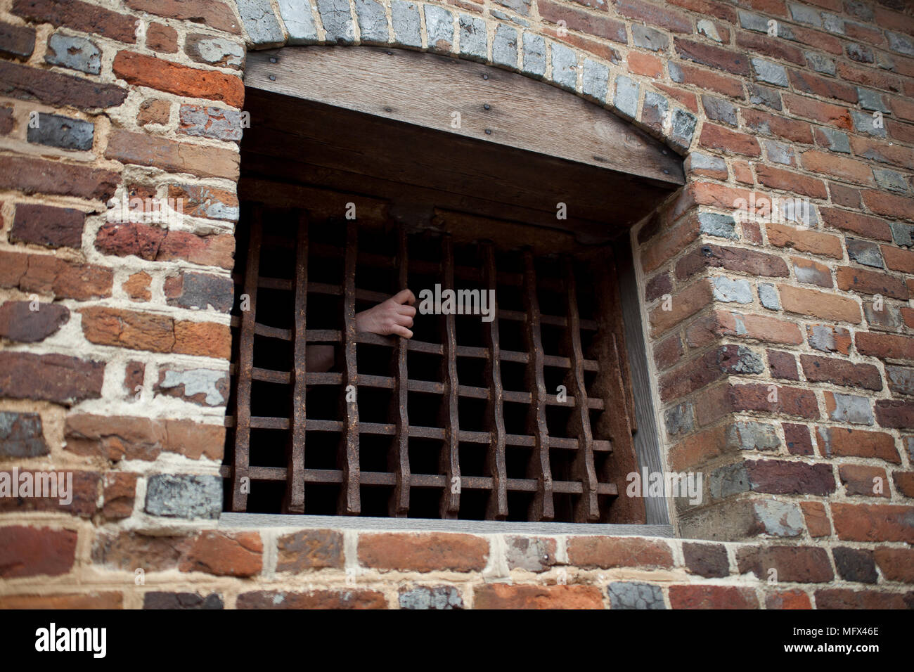 Captive's hands on iron bars in Colonial Williamsburg restored jail ...
