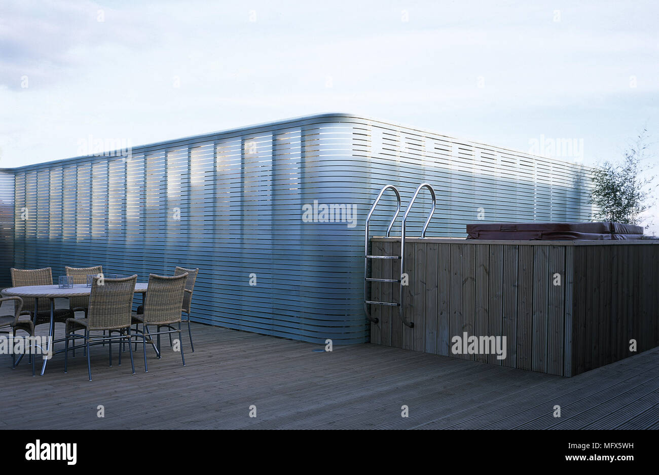 Rooftop terrace with wooden decking, table and chairs, swimming pool ...