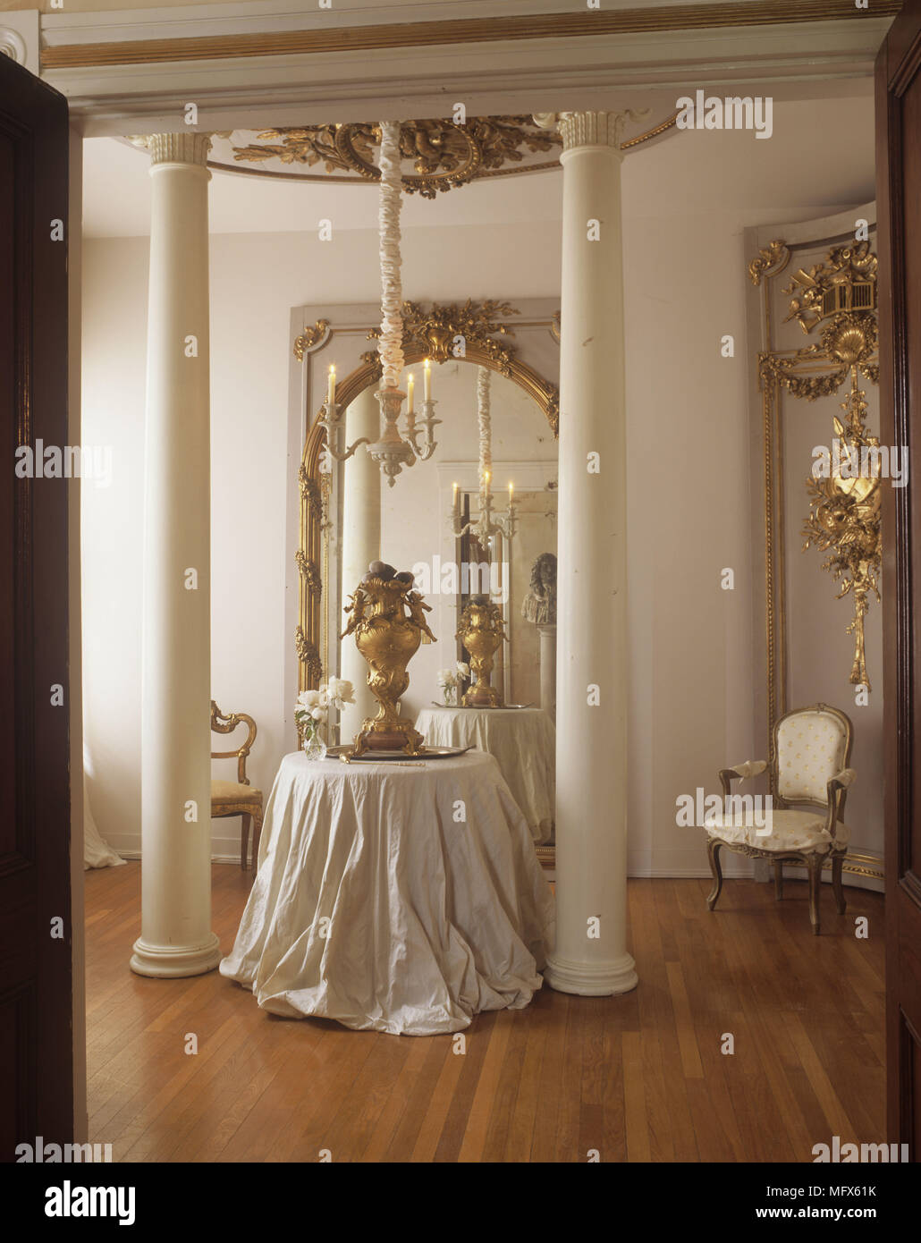 A traditional dining room with a classical theme gilt furniture and ...