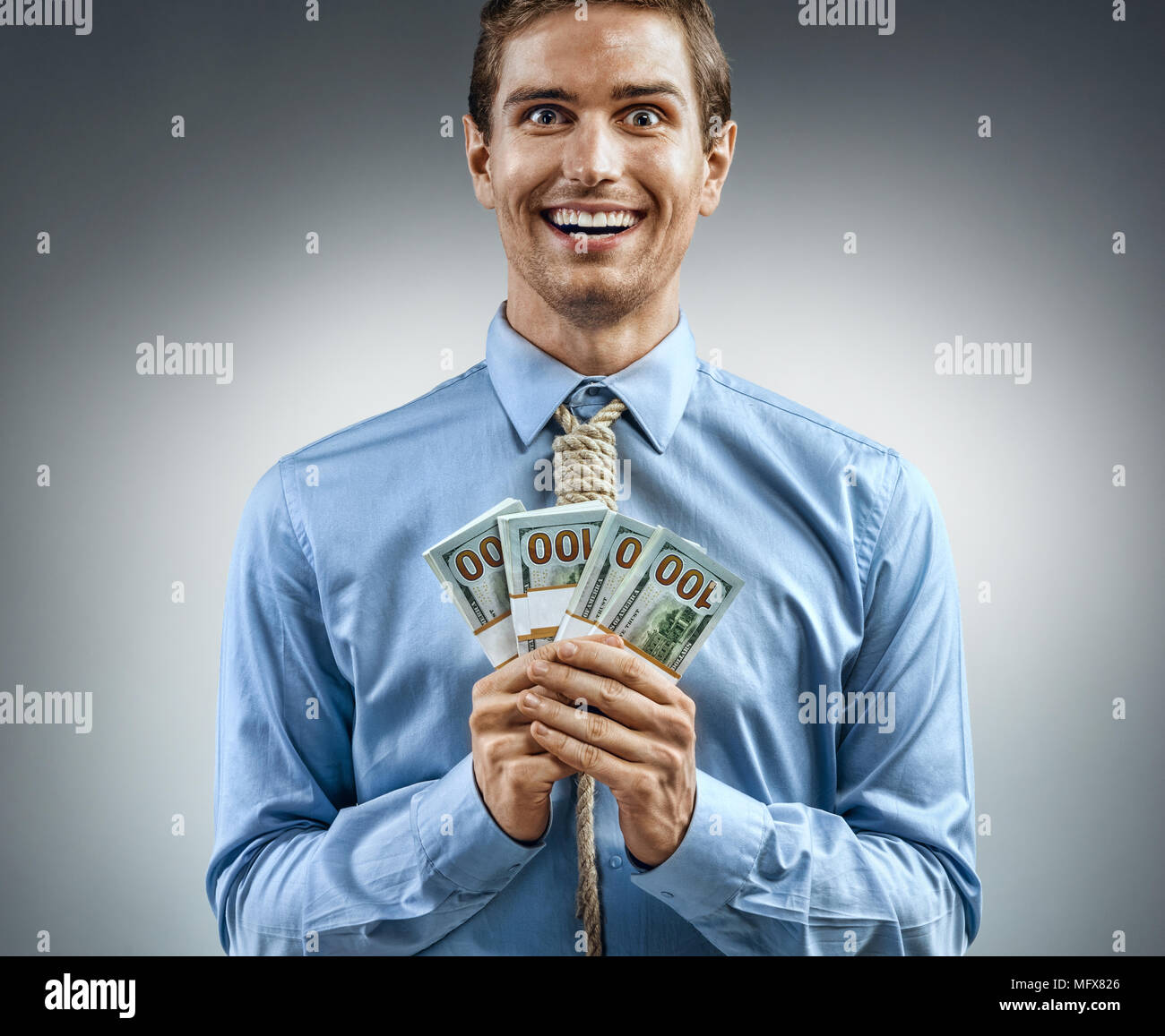 Happy man holding cash money. Photo of smiling man in blue shirt and ...