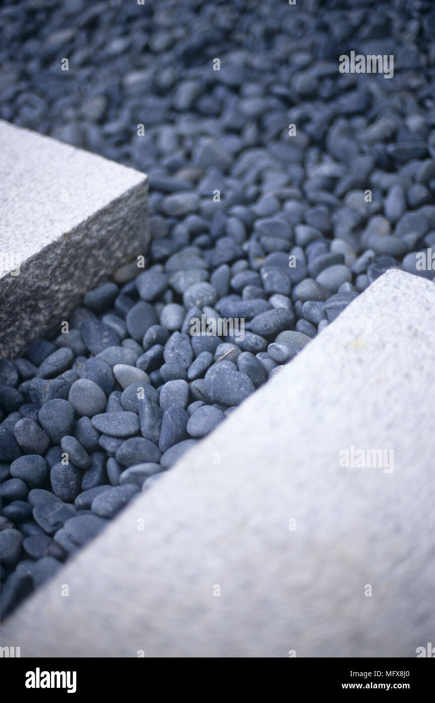 Close up of pebbles in between stone slabs Stock Photo - Alamy