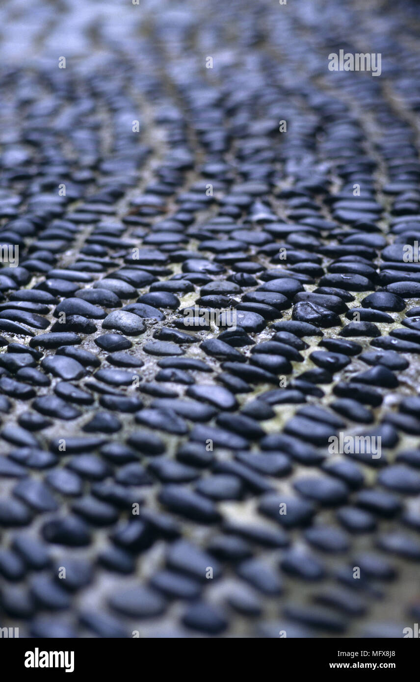 Close up of pebbles encrusted in stone Stock Photo - Alamy