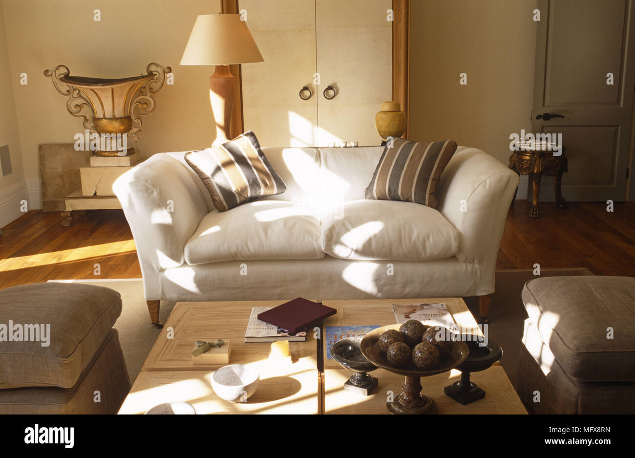 Coffee table in front of upholstered sofa in contemporary sitting room ...