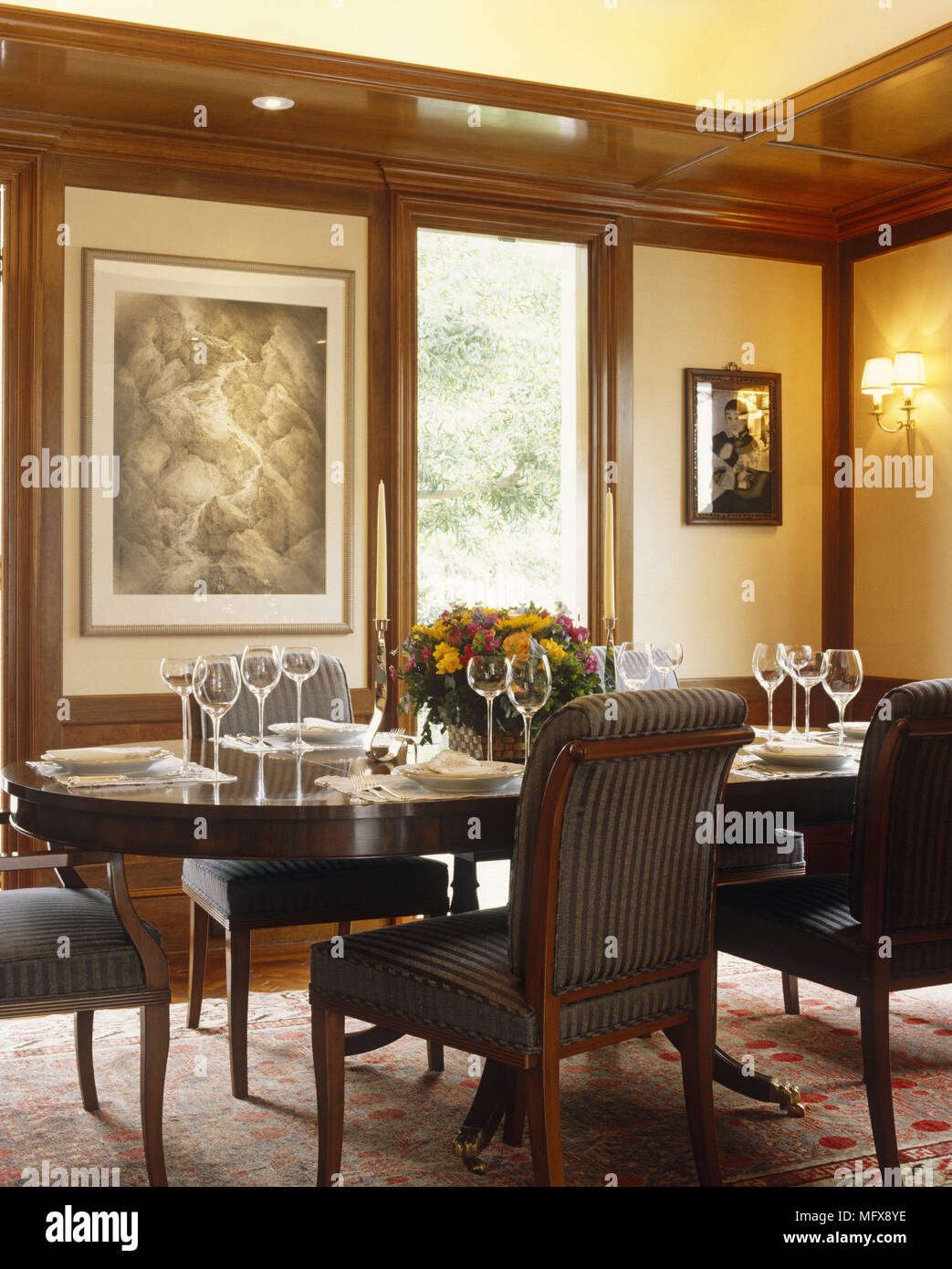 Table set for dinner in traditional style yellow dining room Stock ...