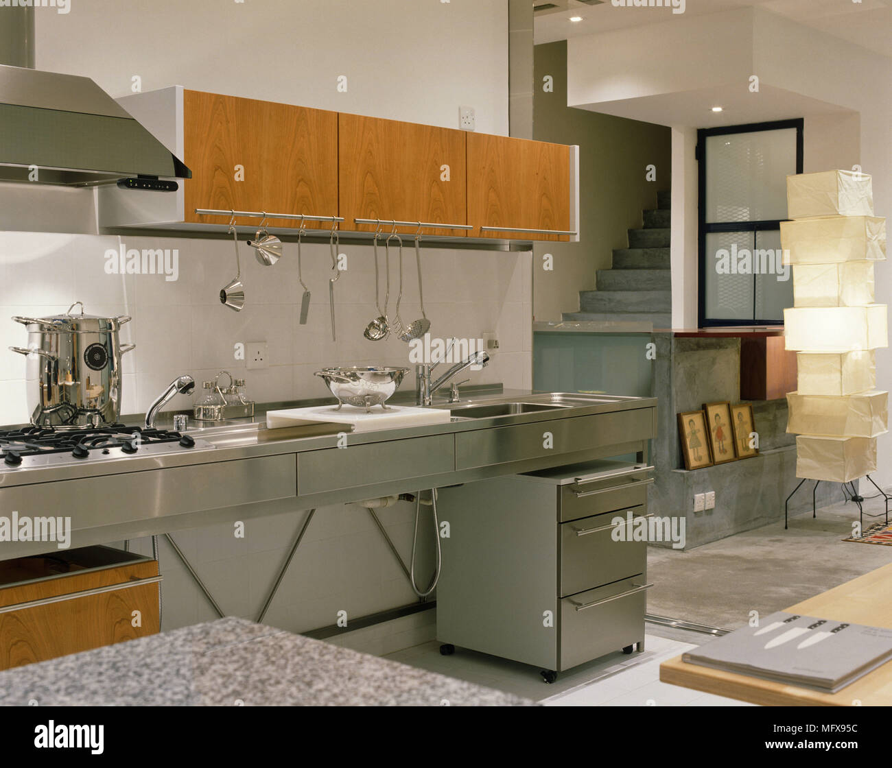 Hob and sink set in stainless steel units in open plan kitchen Stock ...