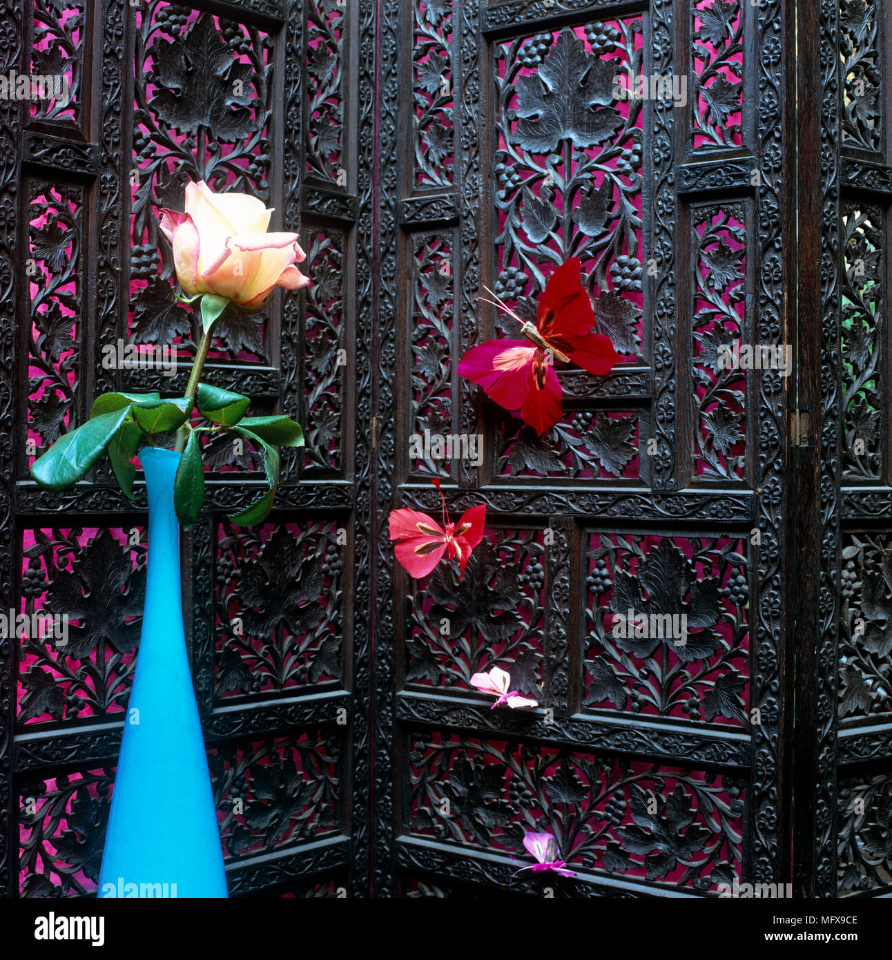 Single rose in blue vase in corner of room Stock Photo - Alamy