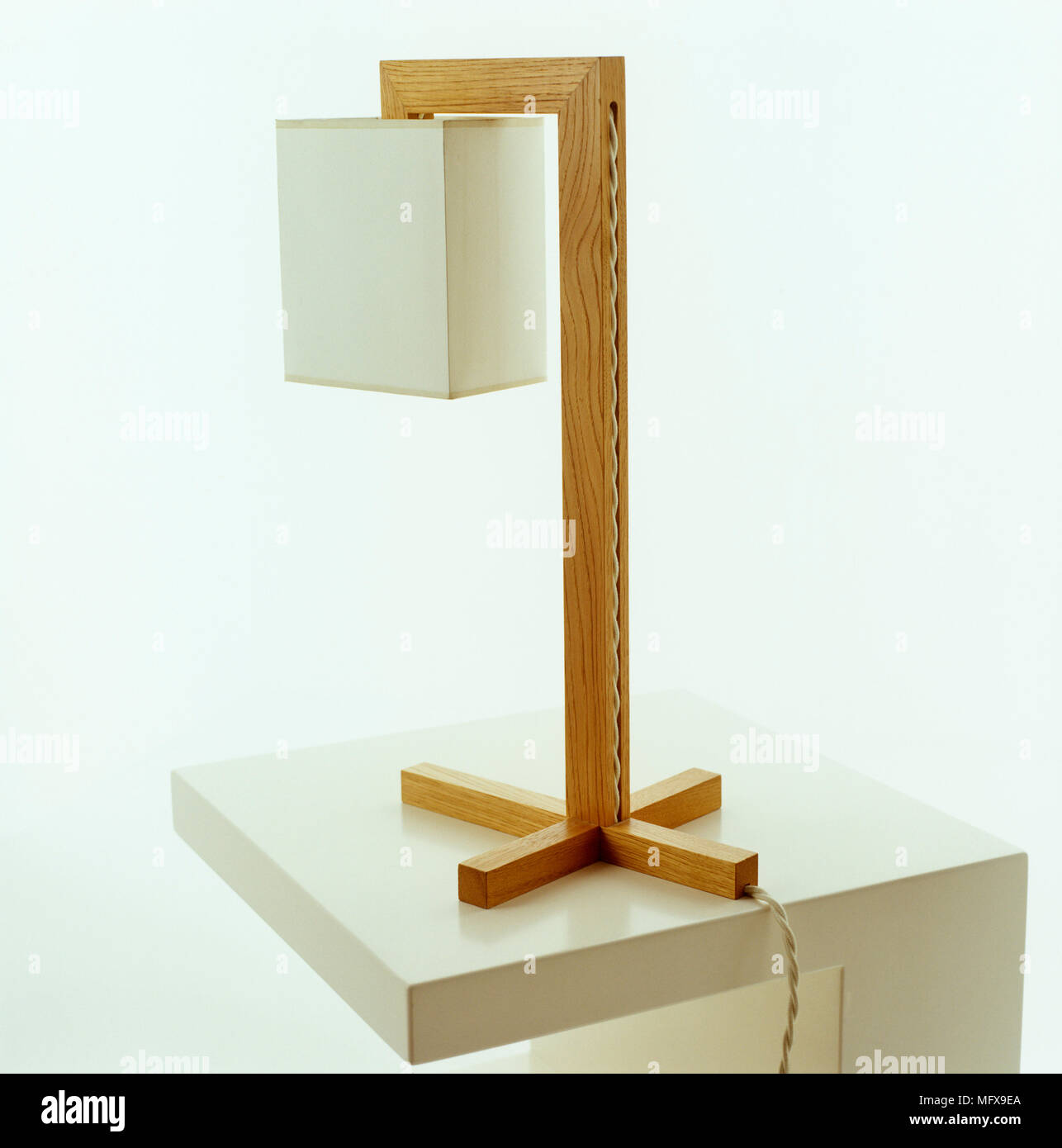 Modern wooden lamp on white table Stock Photo - Alamy