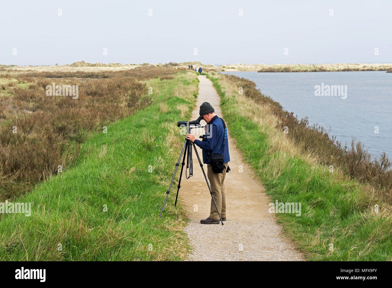 Bird watcher at Titchwell, an RSPB nature reserve in North Norfolk ...