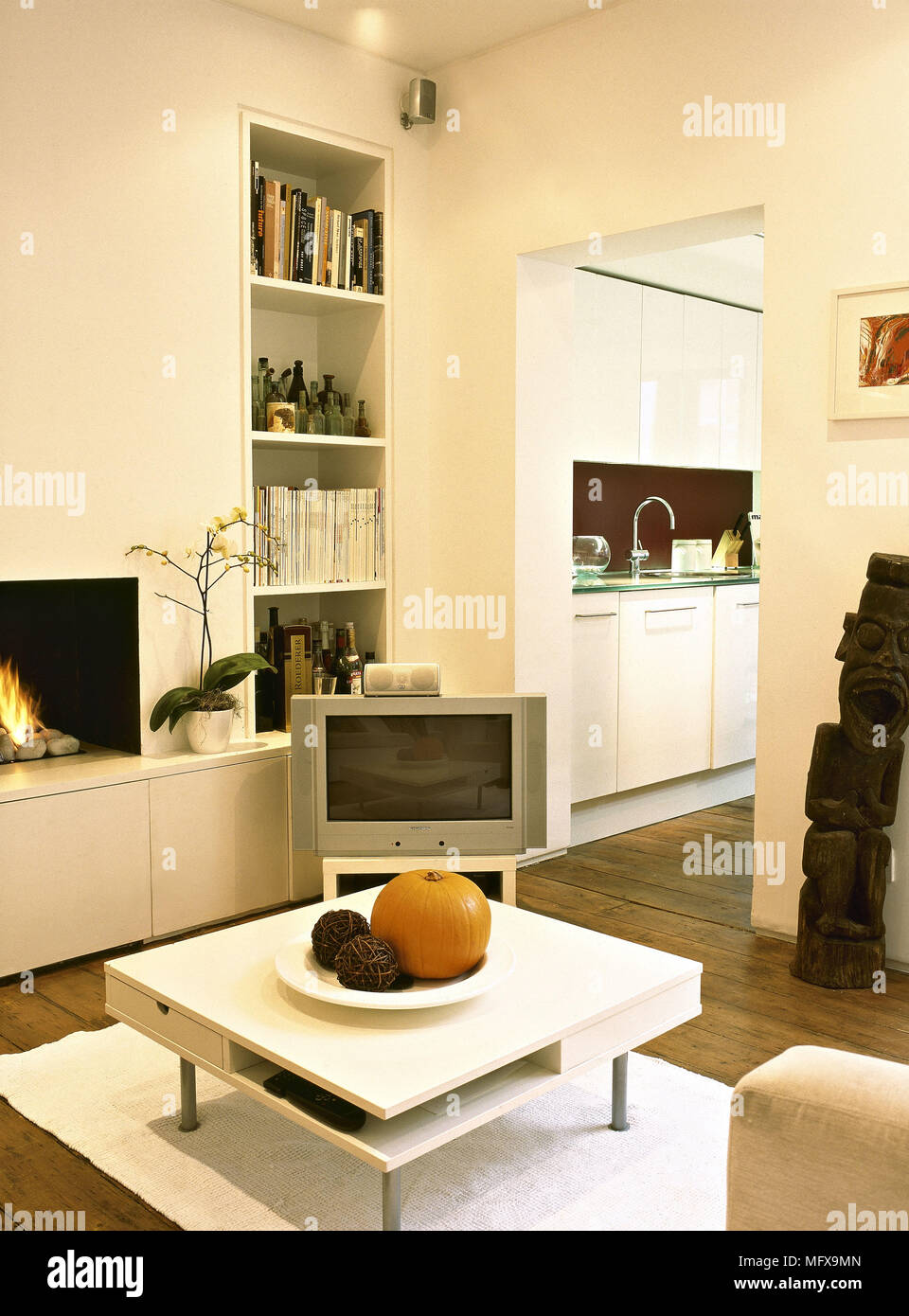 View through sitting room with square coffee table to kitchen Stock ...
