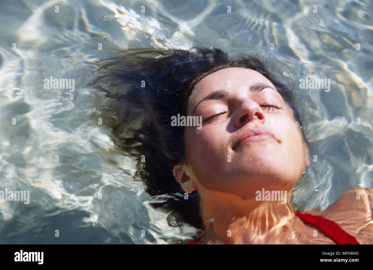 A detail of a woman floating in the sea Stock Photo - Alamy