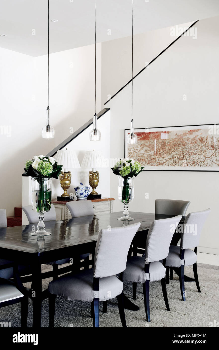 Ceiling lights above table and chairs in modern dining room Stock Photo ...