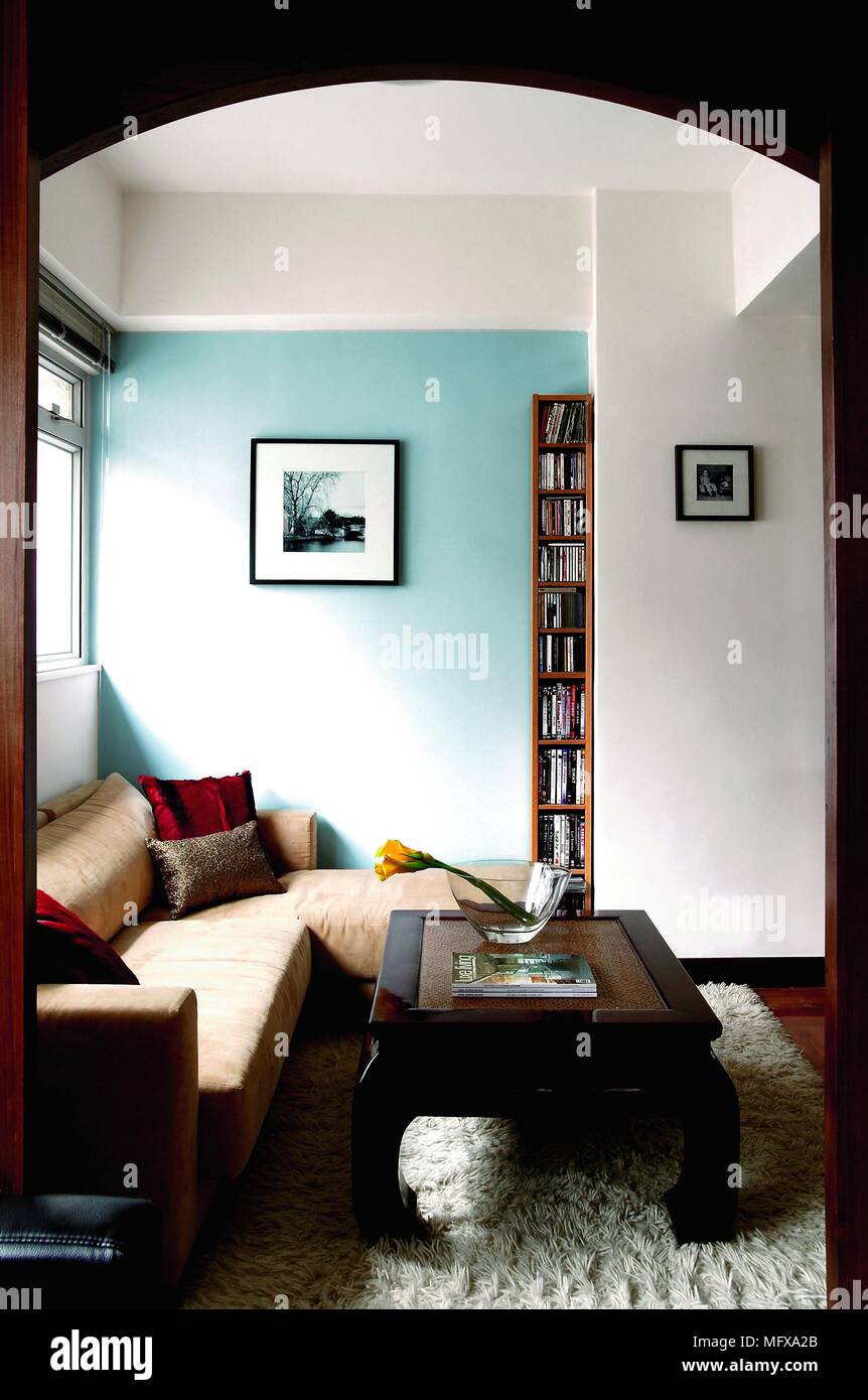 Coffee table in front of sofa in modern blue sitting room Stock Photo ...