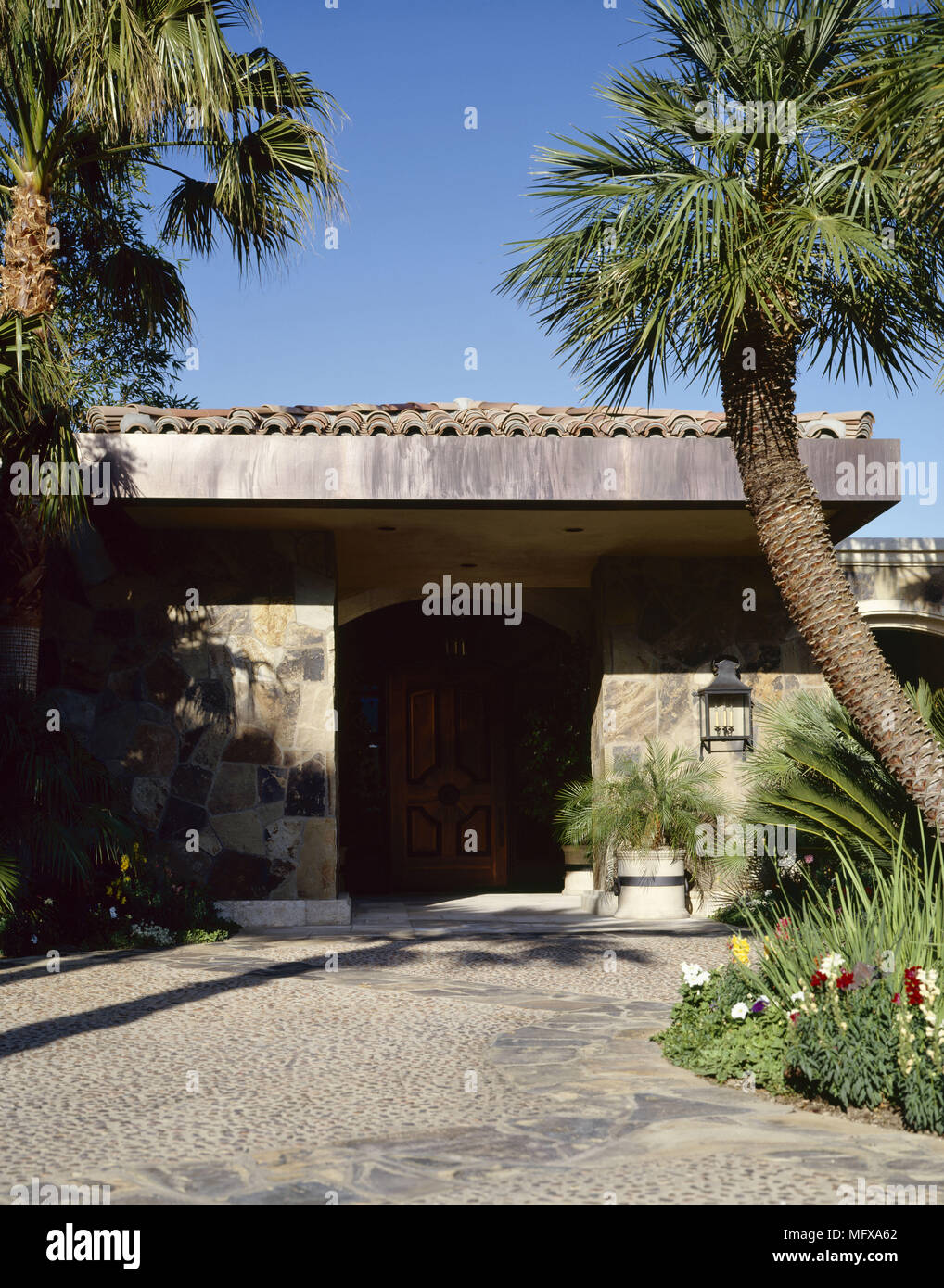 Exterior of new build house with palm trees in front of front entrance ...