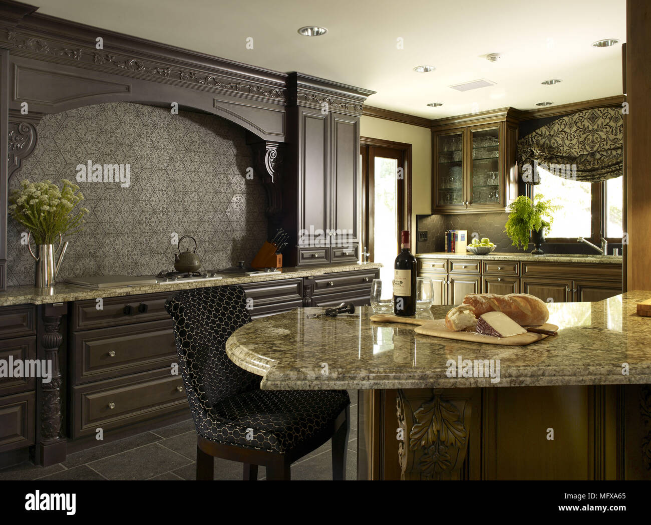 Food and drink on marble topped central island unit in traditional ...