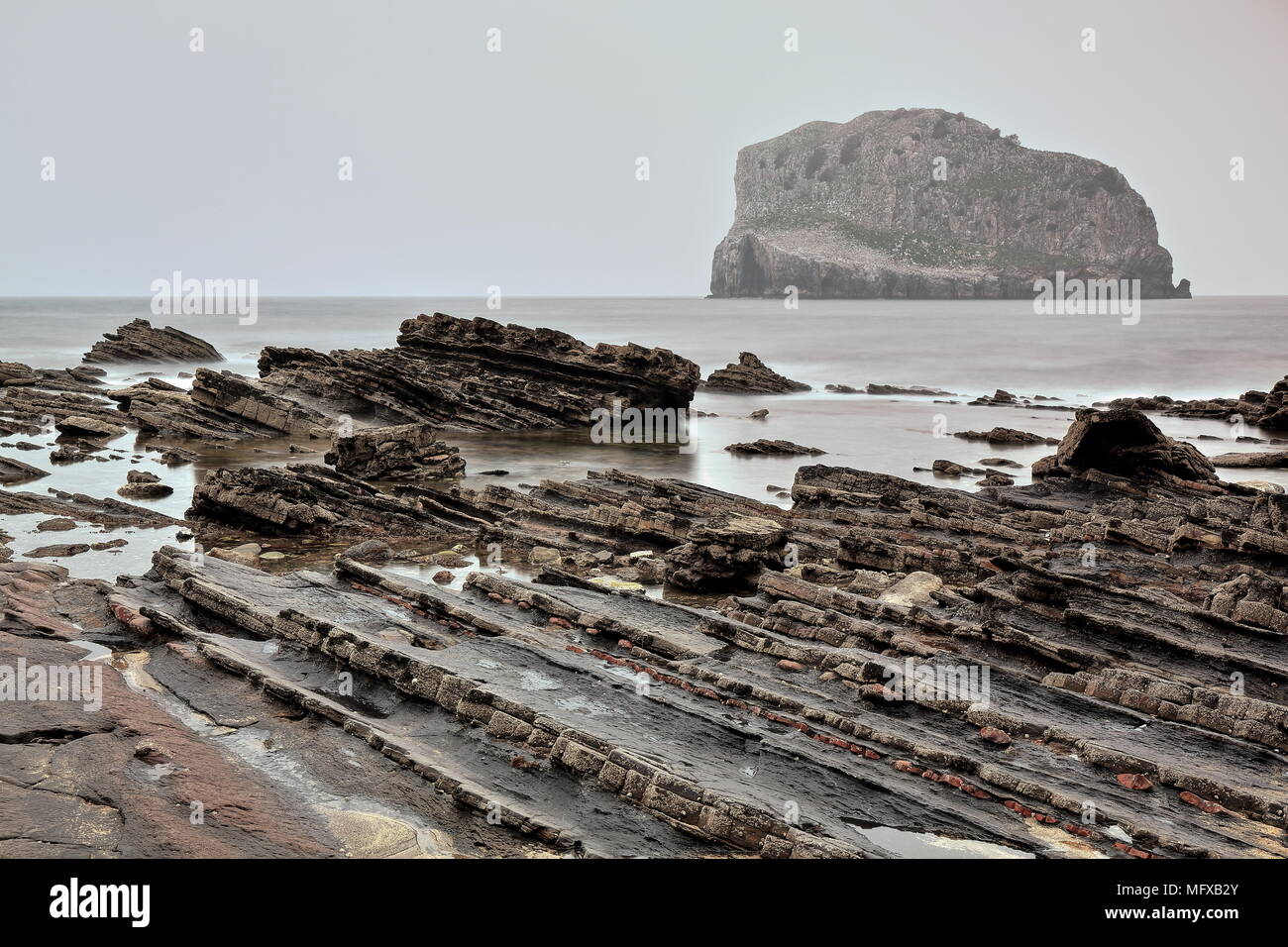 Aketx island to the east of Gaztelugatxe islet across Senaia Kala-cove ...