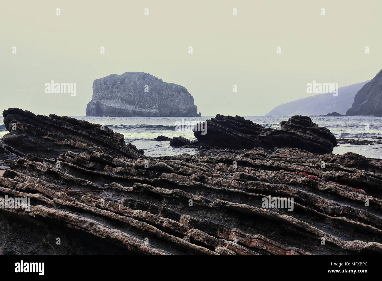 Aketx island to the east of Gaztelugatxe islet across Senaia Kala-cove ...