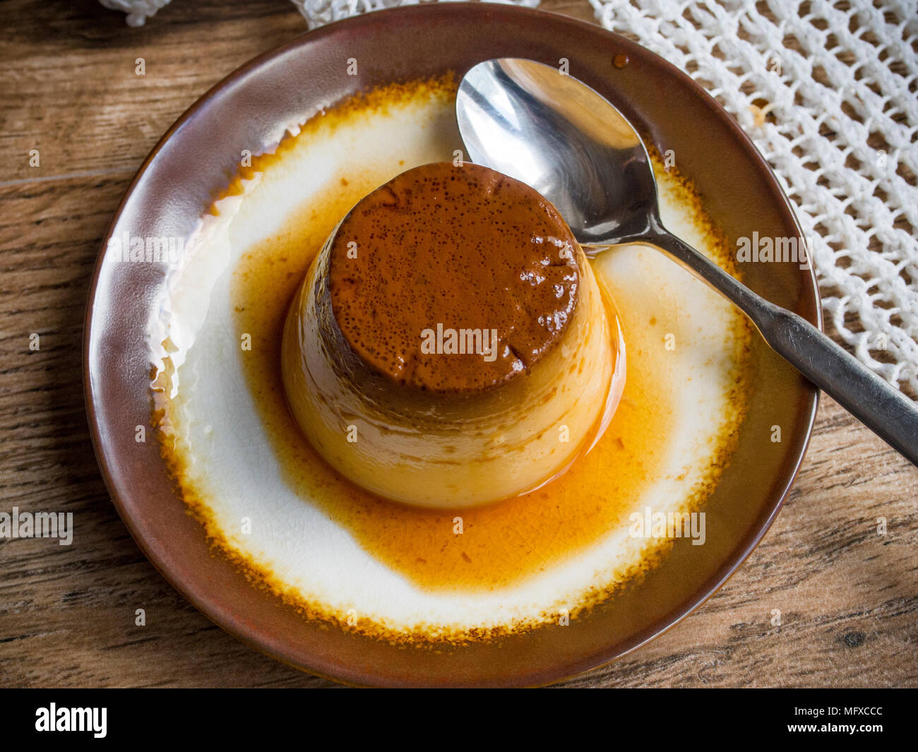 Flan in a plate on wood background Stock Photo - Alamy