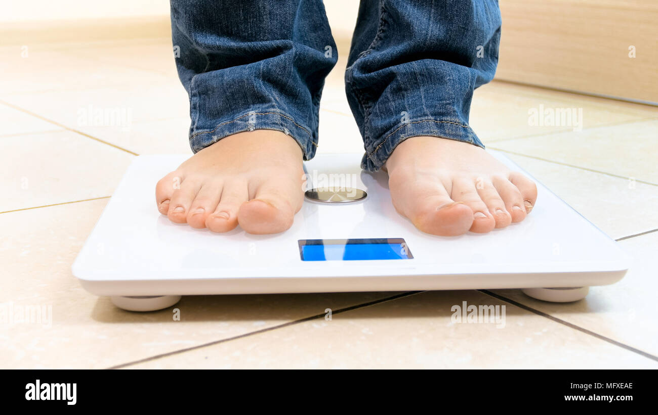 Closeup photo of female feet standing on digital scales Stock Photo - Alamy