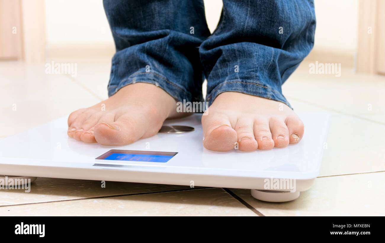 Closeup photo of female feet standing on weights Stock Photo - Alamy