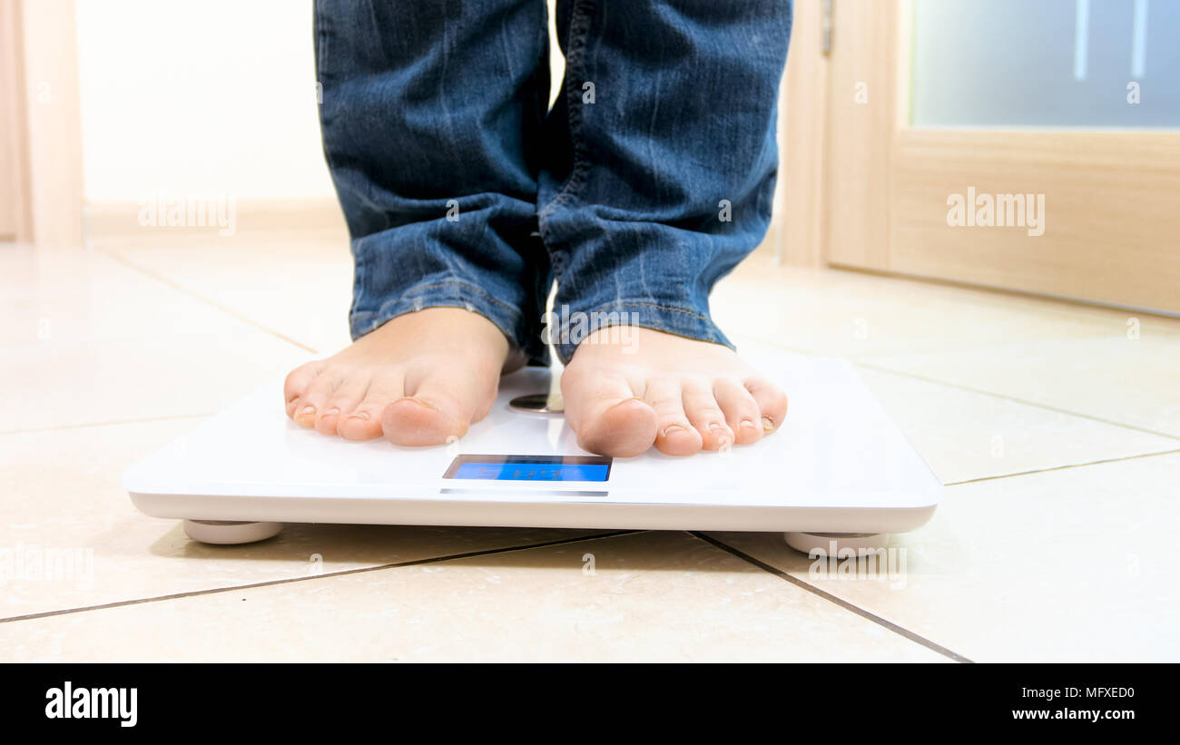 Person standing on scale jeans hi-res stock photography and images - Alamy