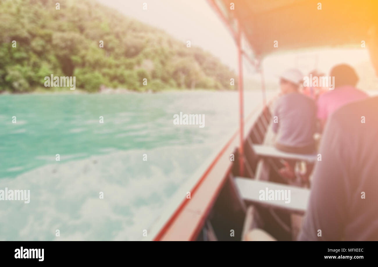 Blurred photo of Row boat in summer crystal clear blue sea under bright ...