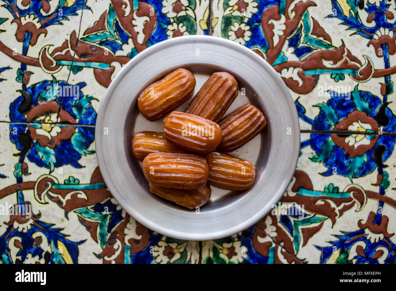 It is a fried batter soaked in syrup, similar to jalebis and churros ...