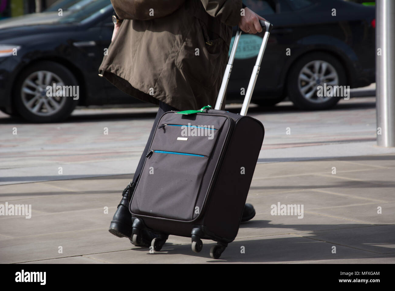 Suit case on wheels Stock Photo - Alamy