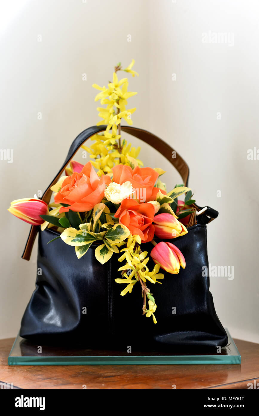 A Flower arrangement in a handbag Stock Photo - Alamy