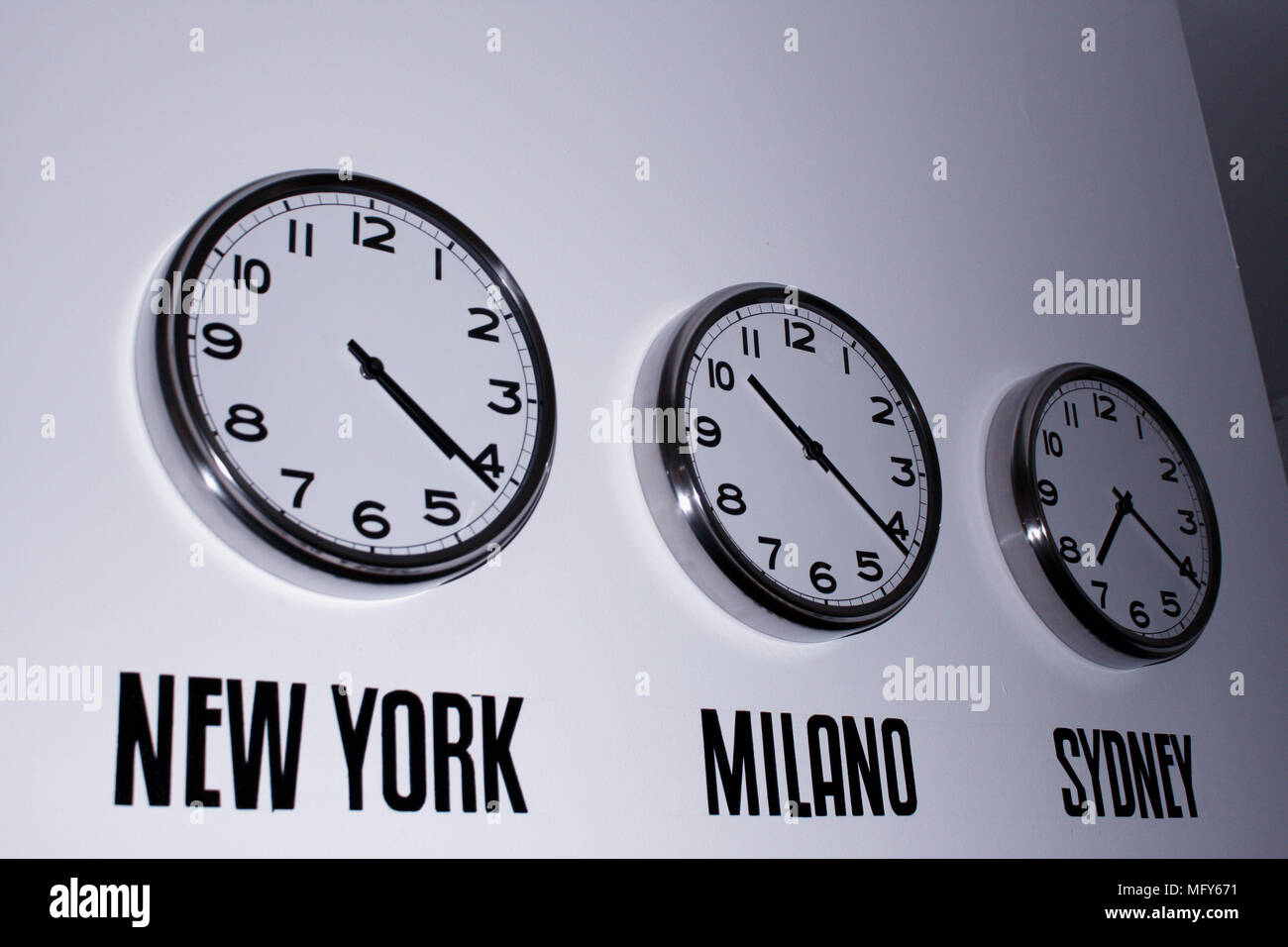 Clock on the wall showing time in the world Stock Photo - Alamy