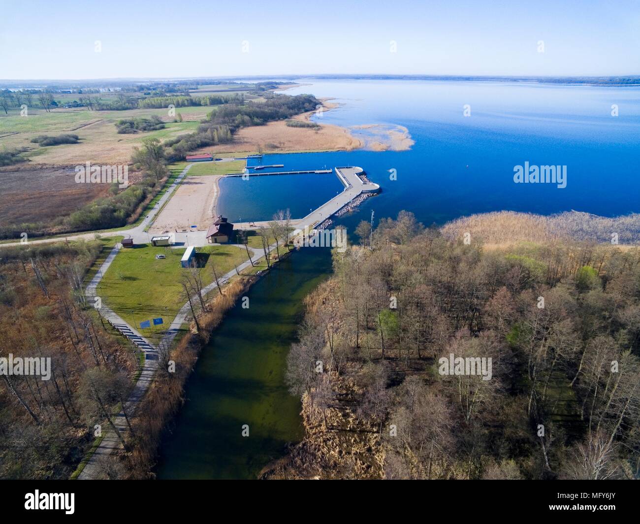 Aerial view of the beach on Mamry lake shore by Wegorapa river estuary ...