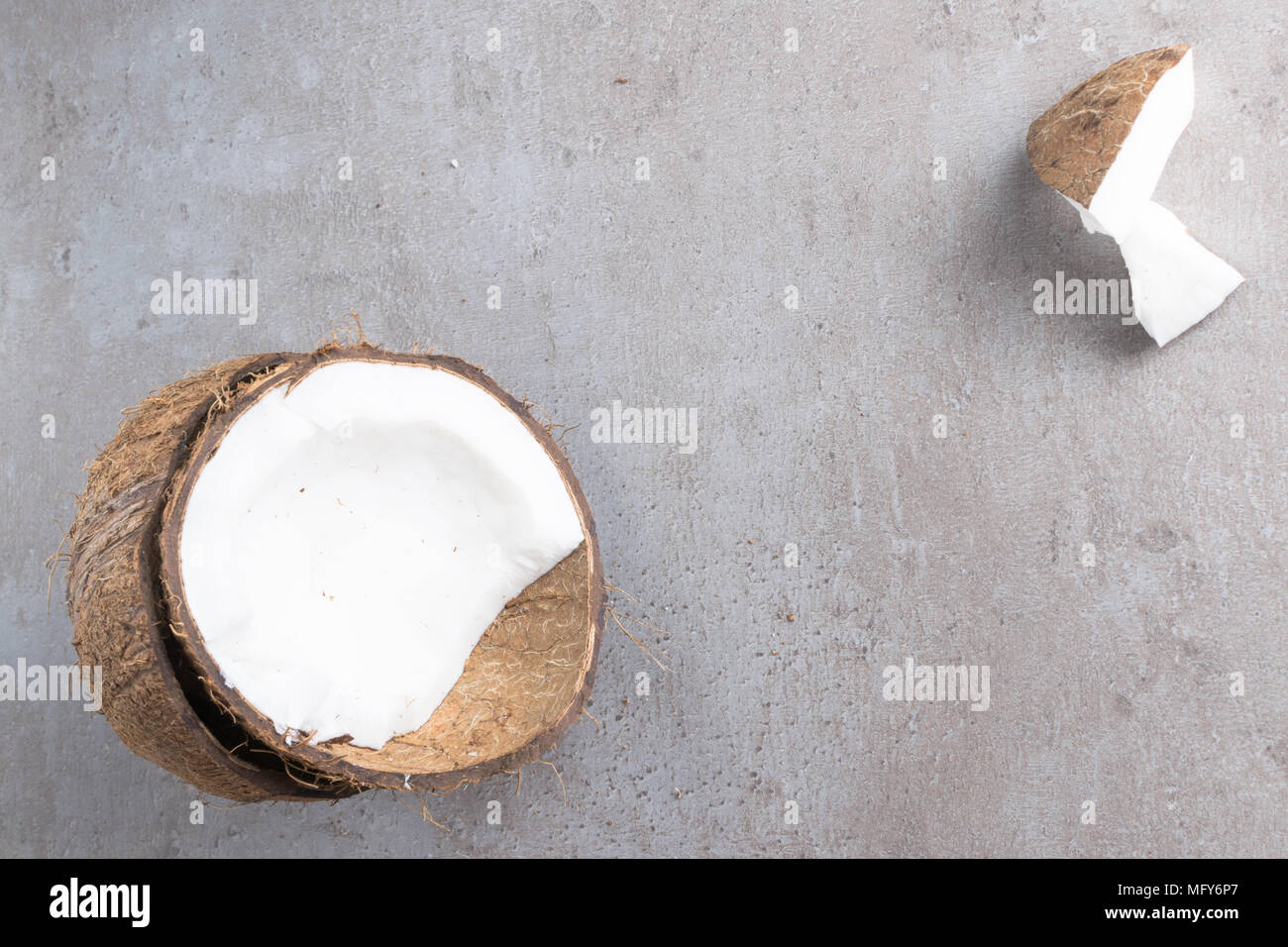 raw organic broken coconut on grey table. Vegetarian food Stock Photo ...