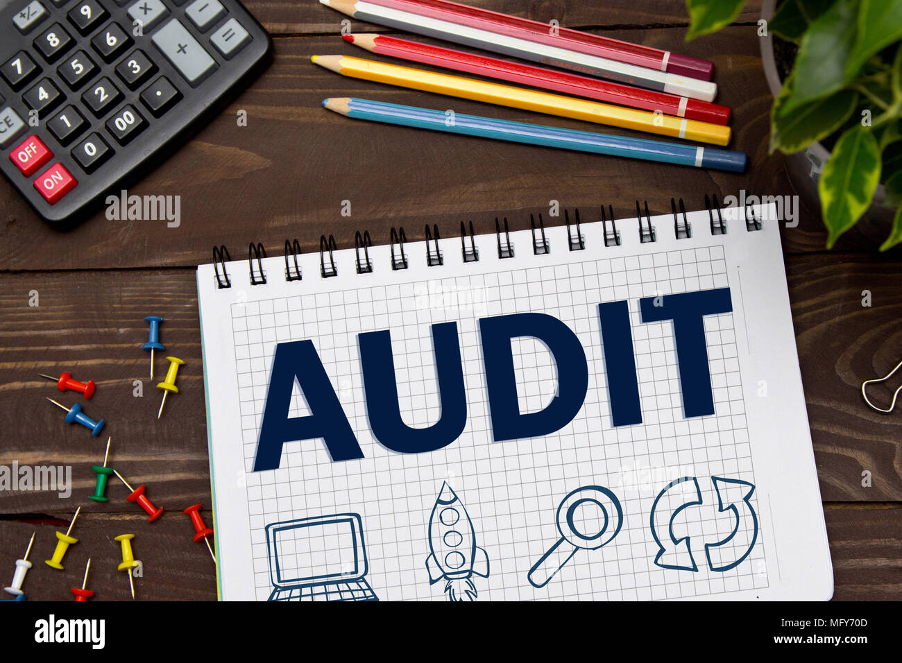Notebook with a Business notes AUDIT on the office table with tools ...
