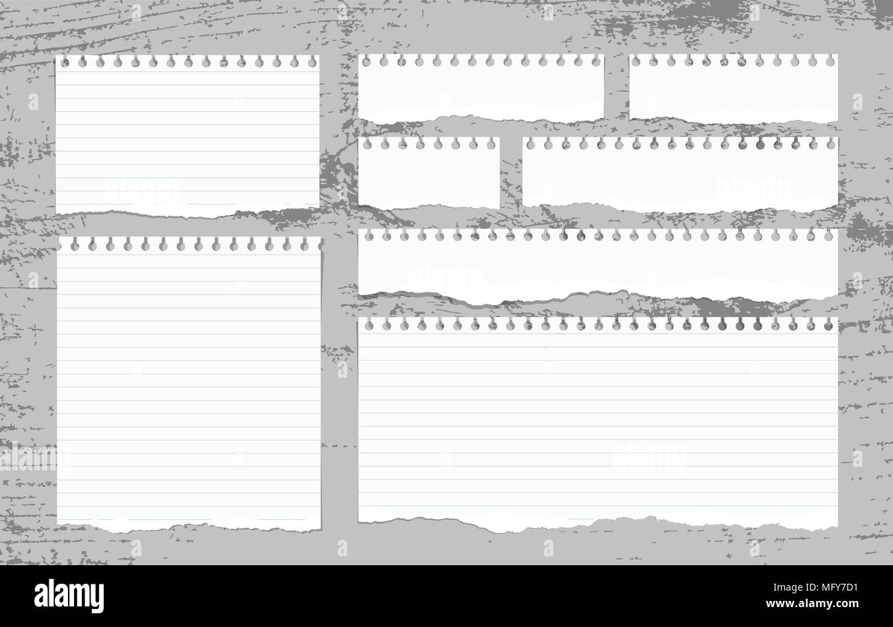 Torn note, notebook lined paper strips are on gray wooden board or ...