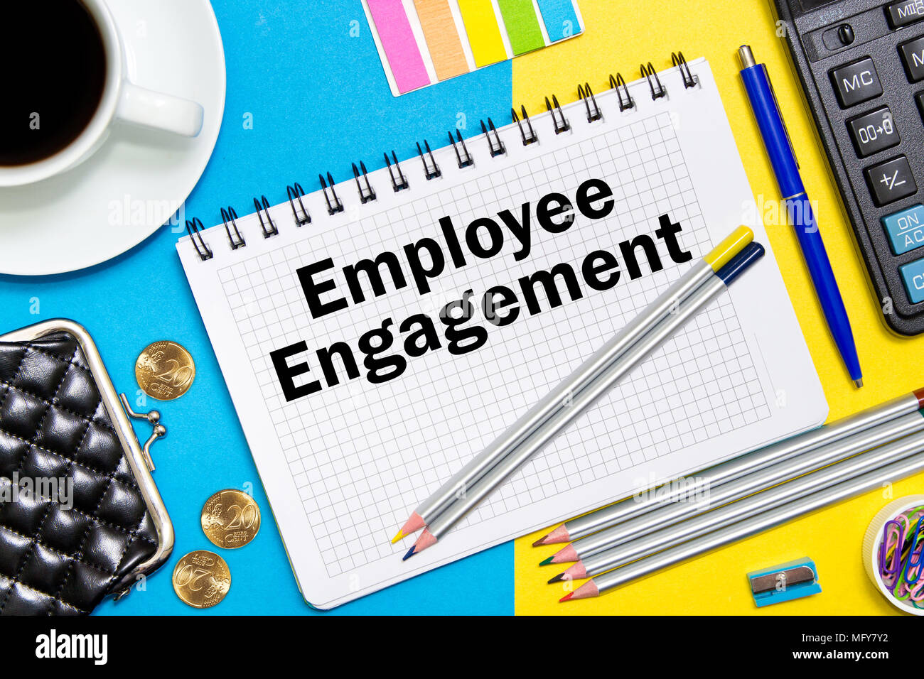 Employee Engagement notes in the notebook on the Desk of a businessman ...