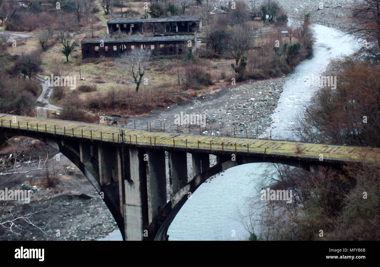 Impressive ruins. Disused railway bridge over mountain river, almost ...