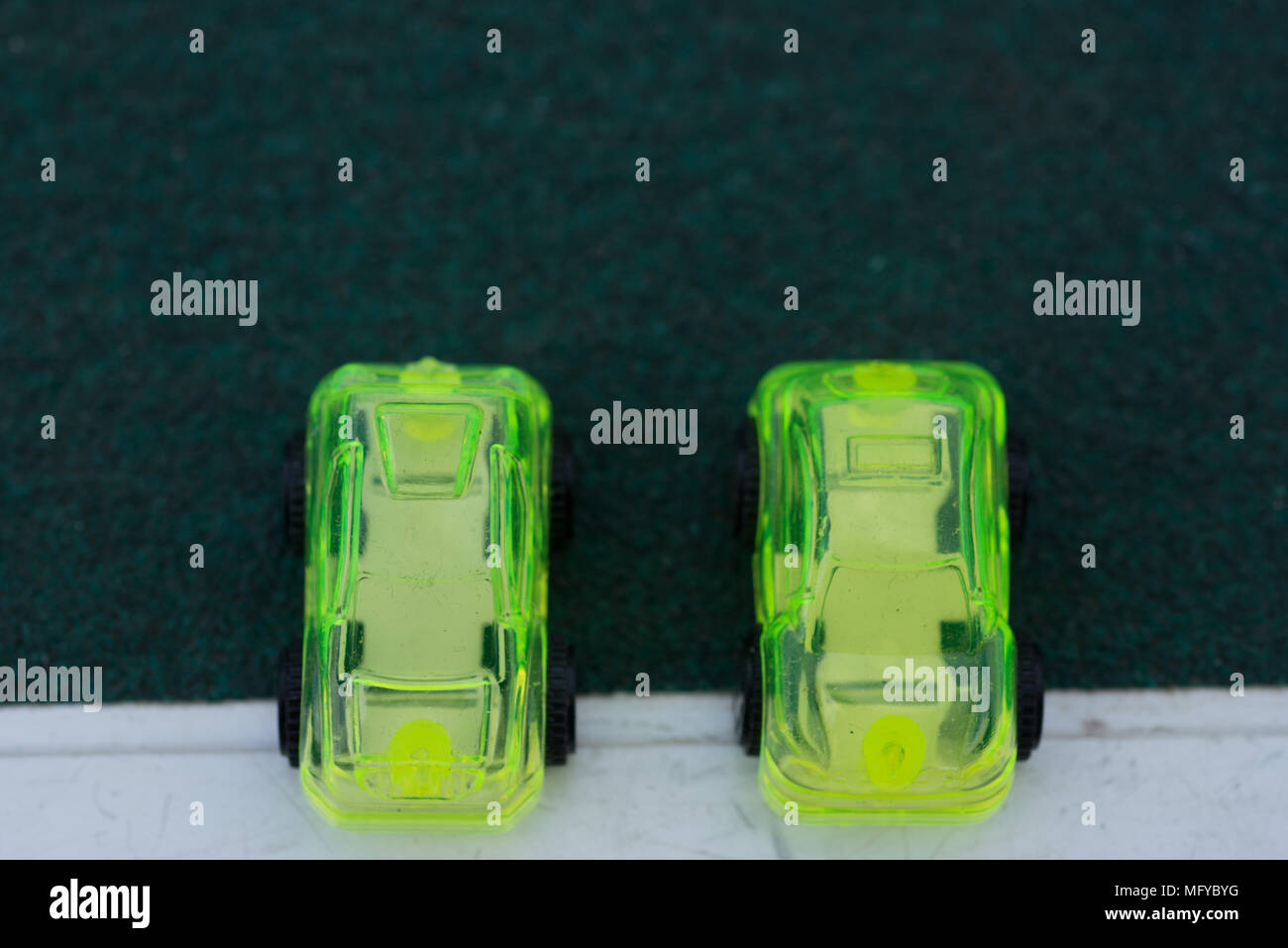 green transparent plastic toy cars on starting line Stock Photo - Alamy