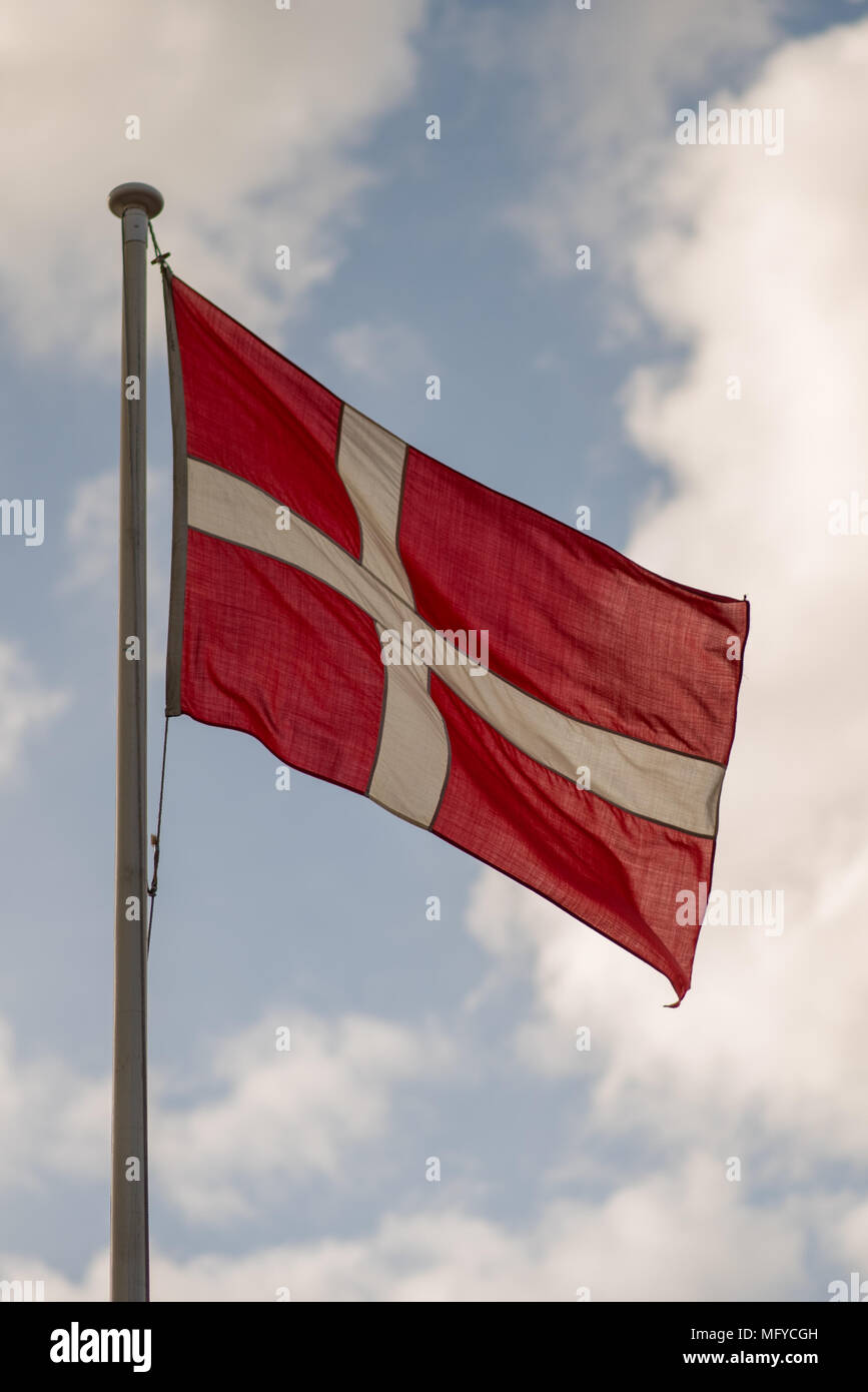 national flag of Denmark blowing in the wind with blue sky and clouds ...