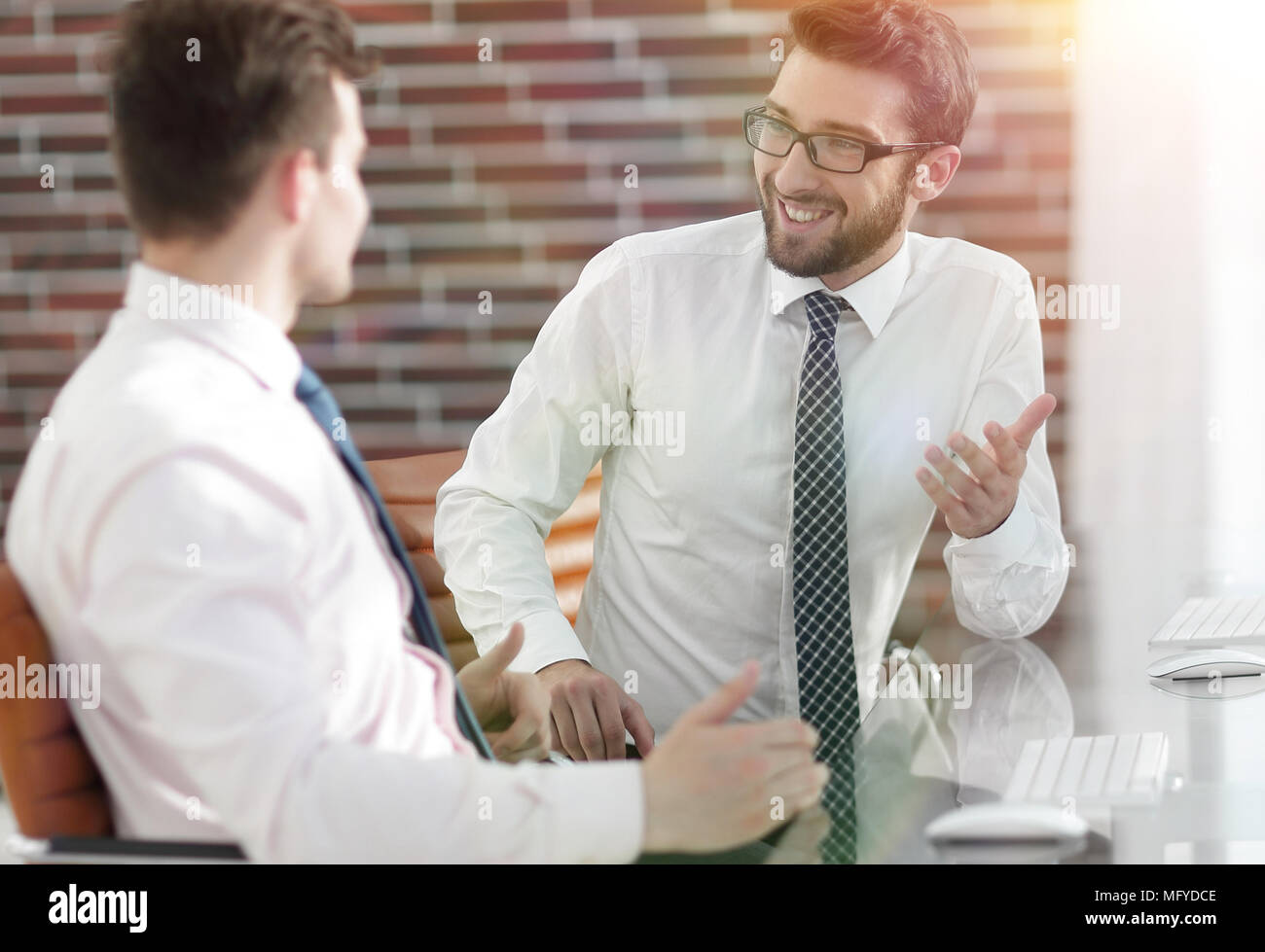 Manager talking with a colleague Stock Photo - Alamy