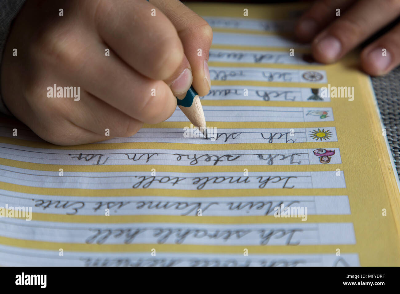 Boy, elementary school student, 8 years old, learns for school at home ...