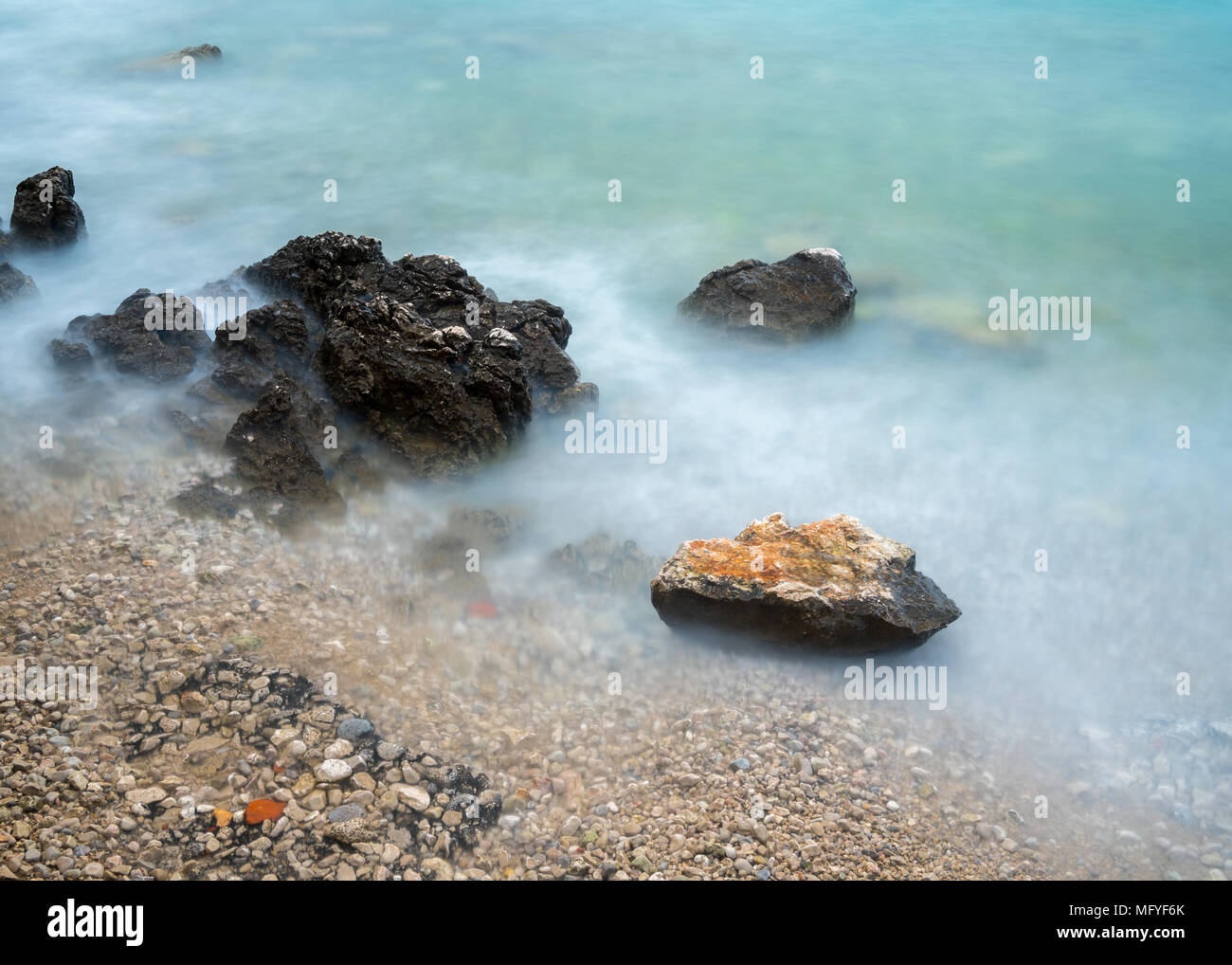 Rocks at the beach, long exposure Stock Photo - Alamy