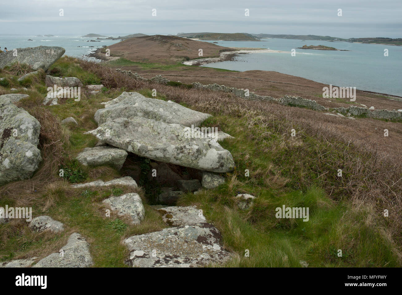 A prehistoric entrance grave with capstones in the foreground with ...