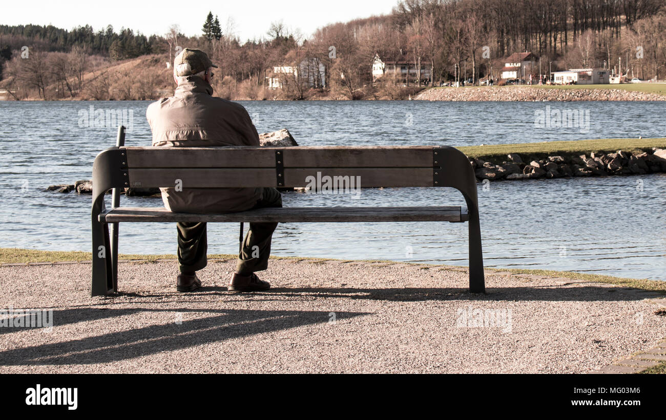 Back of man alone on park bench hi-res stock photography and images - Alamy